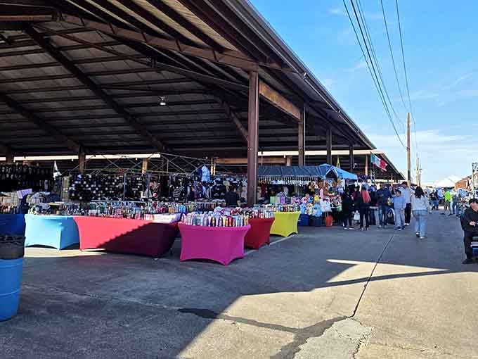 Colorful covered pavilions stretch into the distance, protecting shoppers while they hunt for that perfect unexpected find.