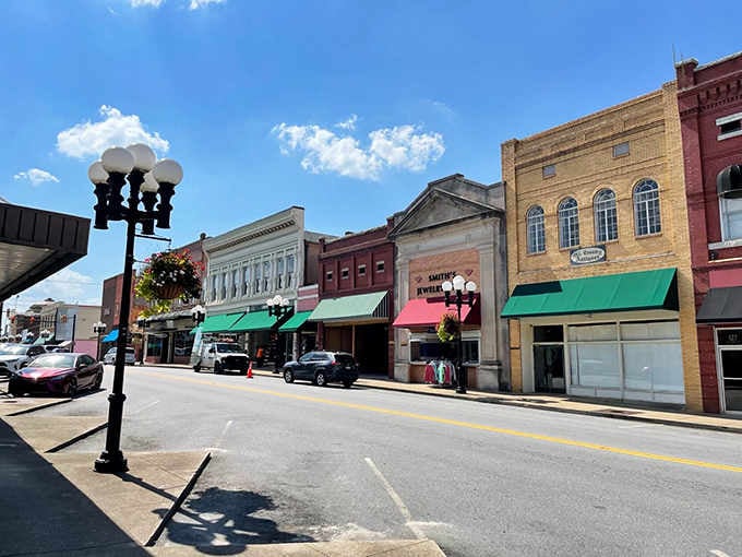 Blue skies frame a downtown where ornate lampposts and awnings create shade for leisurely afternoon strolls.