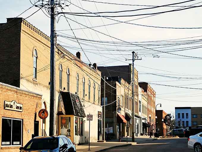 Charming storefronts and historic architecture line the street, capturing the essence of a town that still values its past.