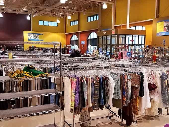 Rows of clothing stretch into the distance like a fabric rainbow, each piece waiting for its second act.