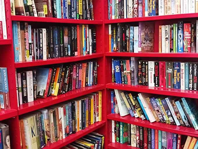 Those bright red book shelves hold more stories than your uncle at Thanksgiving, and they're all affordable.