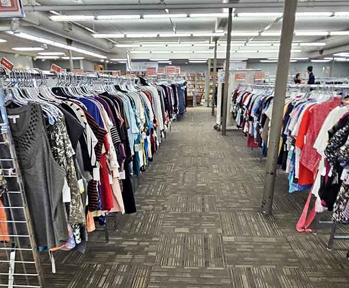 Rows of clothing stretch toward infinity, a fabric rainbow organized by color and endless in possibility.