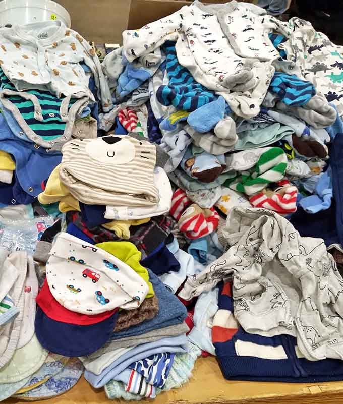 Baby clothes mountain! A parent's paradise where tiny fashion statements cost less than your morning latte, perfect for those growth spurts that happen overnight.