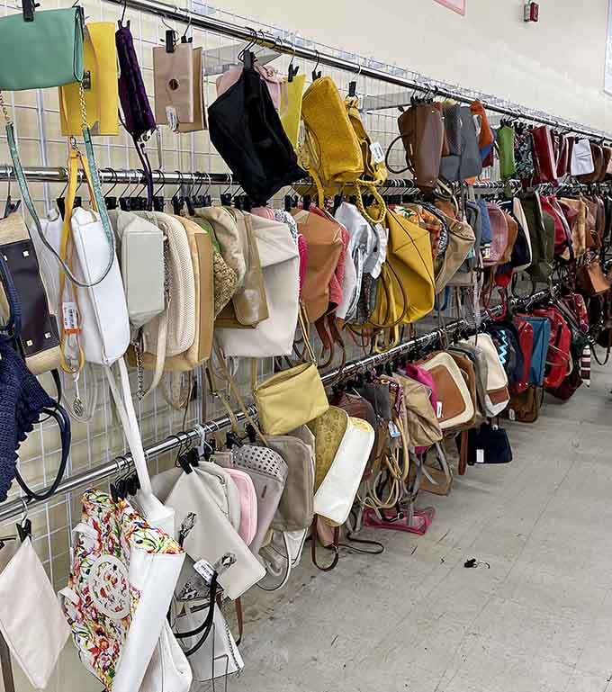Handbag heaven! A rainbow of purses dangling like fashionable fruit, waiting to be plucked for a fraction of retail.