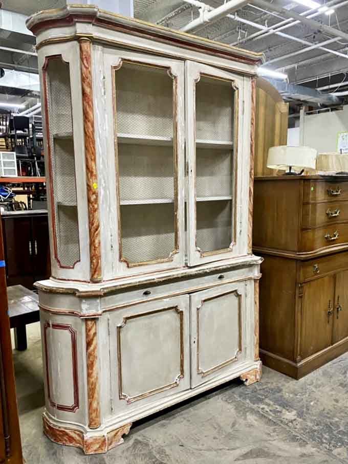 This distressed vintage china cabinet has stories to tell&mdash;and plenty of space for your own collection of mismatched family heirlooms.