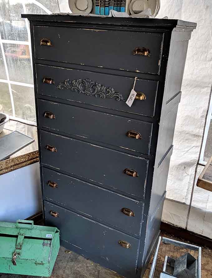 This stately black dresser has witnessed more family secrets than a therapist. Those brass pulls have stories to tell!