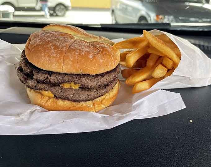 Two patties of pure nostalgia on a toasted bun, this is what burgers looked like before they needed architecture degrees.