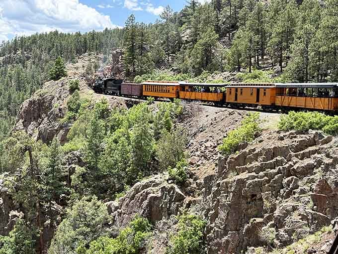 Clinging to cliffsides like a determined mountain goat, this train redefines the meaning of scenic route.