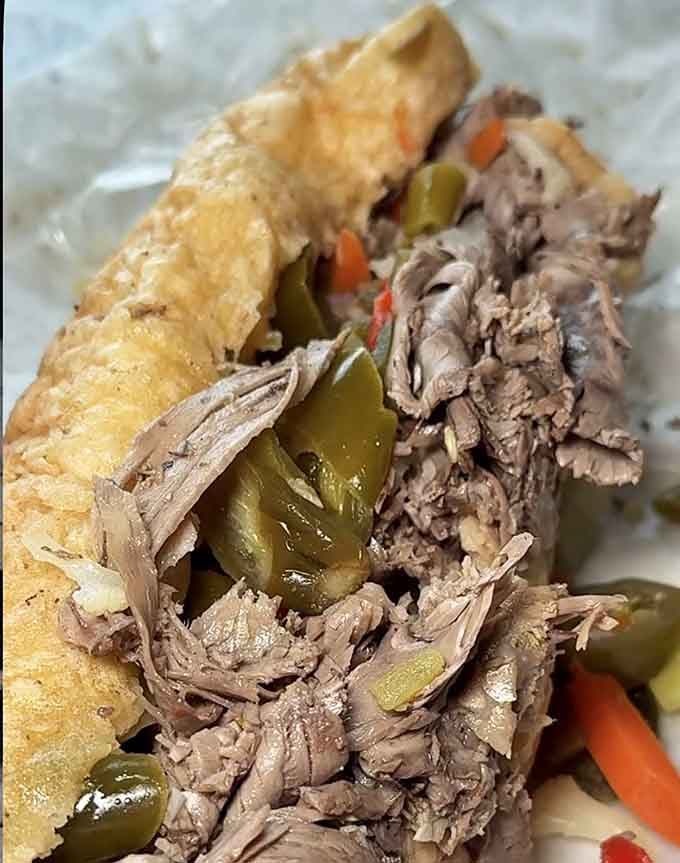 This is what an Italian beef should look like: tender meat, glistening peppers, and bread ready for battle.