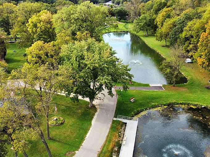 The Root River winds through town like nature's own lazy Sunday afternoon, proving water features beat traffic features every time.