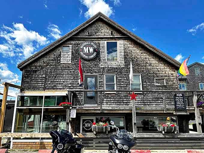 This weathered wooden building houses Marshall Wharf Brewing Company, where coastal views complement craft beers. Like a salty sea captain in architectural form.