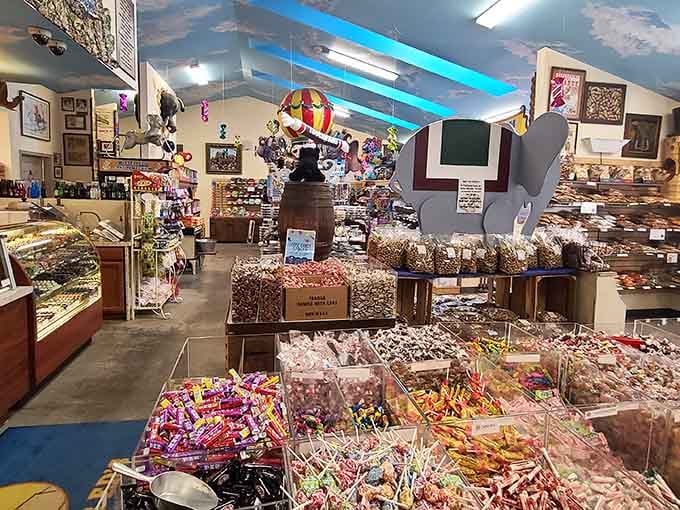 Candy bins stretch endlessly beneath a sky-painted ceiling where hot air balloons float above your sugar-fueled dreams.