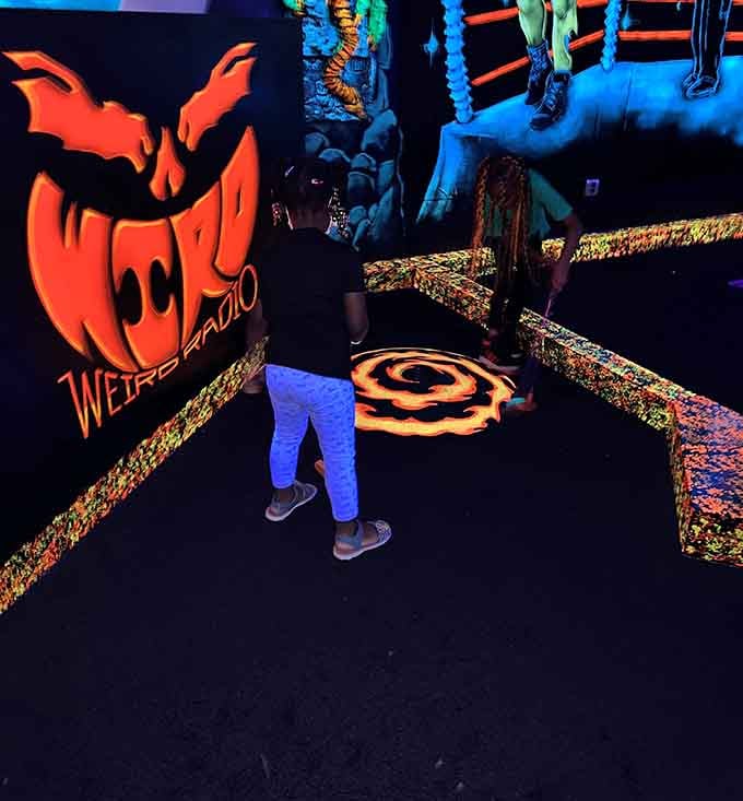 That moment when mini golf becomes an adventure through a blacklight wonderland of glowing obstacles and creatures.