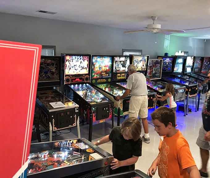 The right wall lineup showcases decades of pinball evolution, each machine ready to tell its own story through flippers and steel.