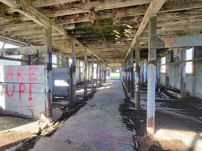 Walk these empty corridors where cows once stood, and you'll feel history whispering through every weathered beam.