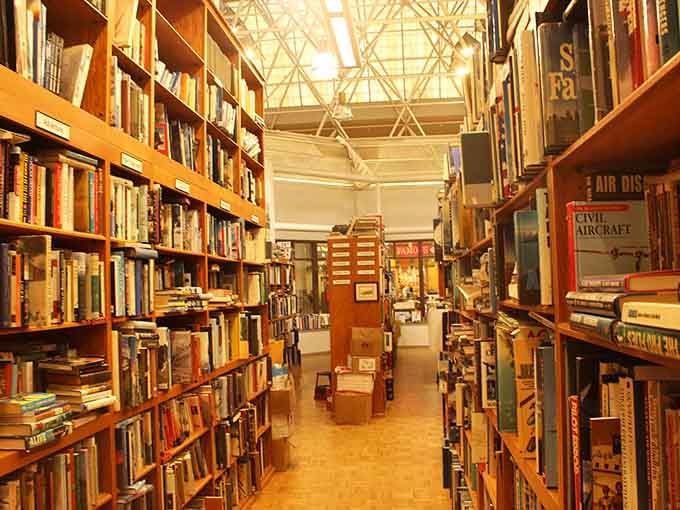 These towering shelves stretch toward the ceiling like a bibliophile's version of climbing Mount Everest.