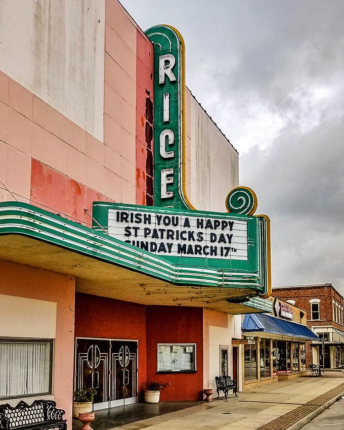 The Rice Theatre's vintage marquee glows with small-town wit, proving puns are alive and well in Acadiana.