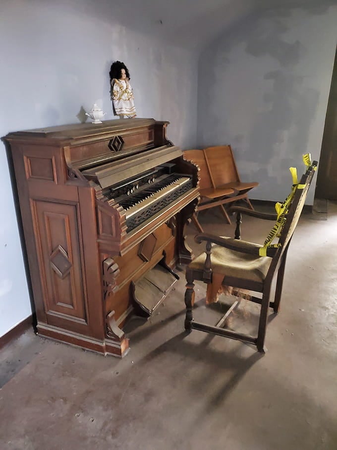 An antique reed organ sits silent now, but you have to wonder what melodies once echoed through these halls.