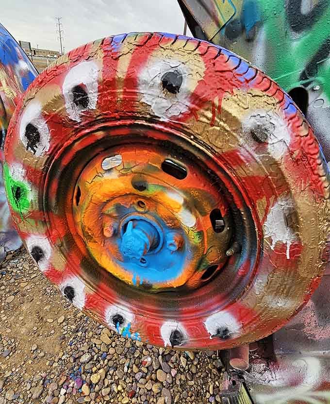 These tires have seen more colors than a Skittles factory explosion, each layer telling stories of passing travelers.