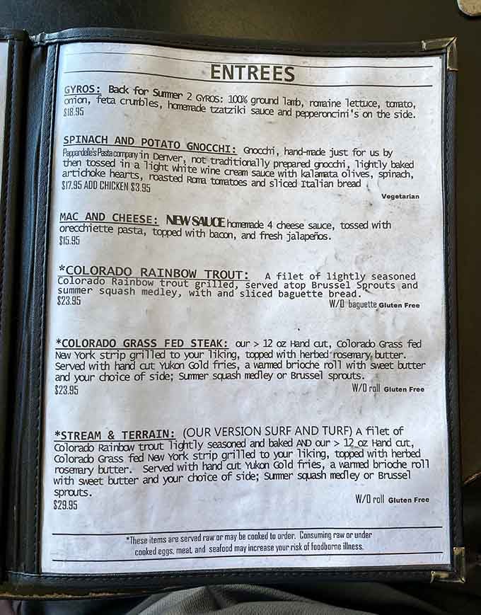 The menu reveals serious commitment to quality, from grass-fed steaks to Colorado rainbow trout prepared with care.