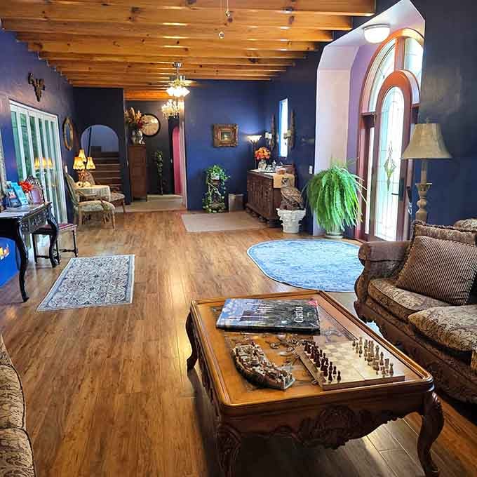 Navy walls and chess sets suggest this living room takes game night more seriously than your average den.