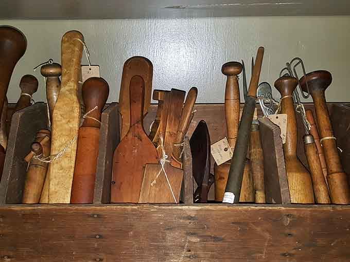 Wooden kitchen tools that survived generations of use, each handle worn smooth by countless hands preparing family meals.