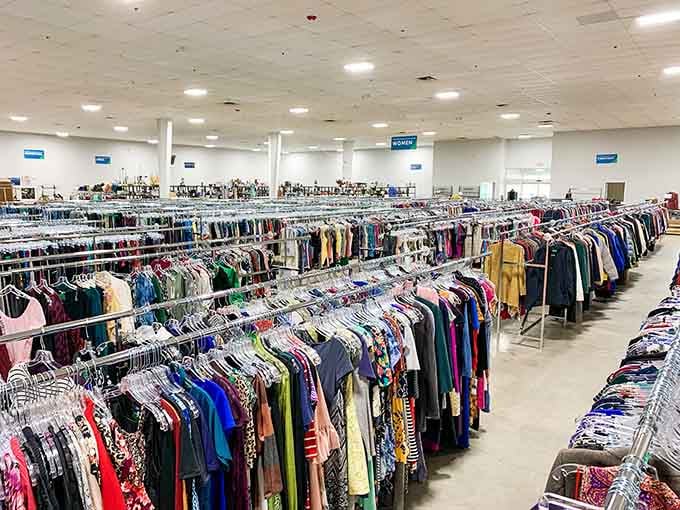 Rows of clothing stretch into the distance like a rainbow made of fabric, organized chaos at its finest.