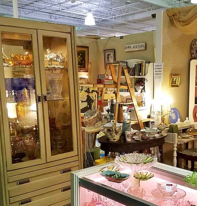 The Junk Sisters booth showcases the perfect marriage of organization and chaos&mdash;where vintage glassware meets mid-century charm in a delightful jumble of nostalgia.