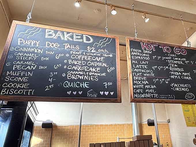 The chalkboard menu reads like poetry to carb enthusiasts—Puppy Dog Tails, sticky buns, and coffee concoctions that make mornings worthwhile.