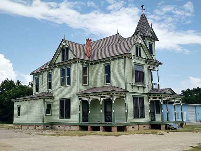 Victorian elegance meets Texas practicality in this mint-green historic home, where ornate details whisper tales of a time when porches were for conversation, not Instagram.