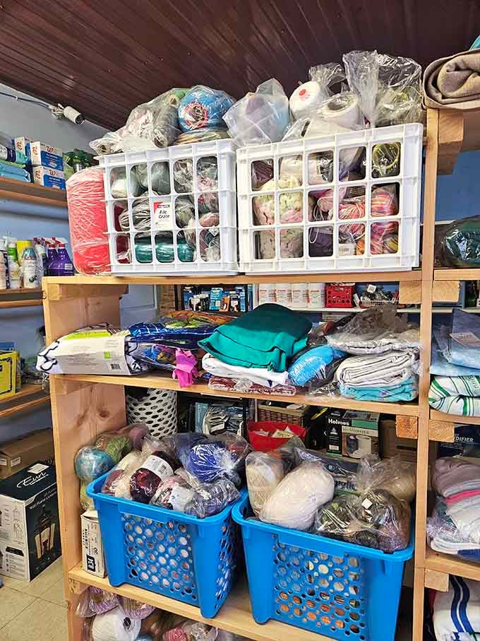 Fabric heaven for crafty souls. Blue walls frame a rainbow of textiles waiting to transform from forgotten remnants into someone's next heirloom project.