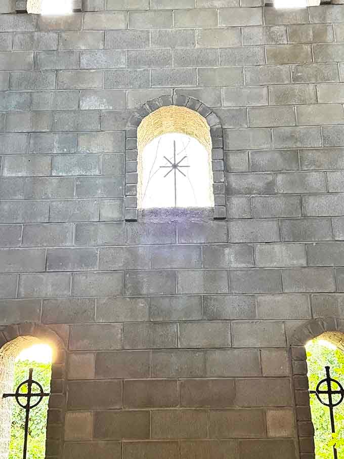 These aren't your standard Florida picture windows. Cross-adorned openings filter light through stone walls, creating an atmosphere that whispers rather than shouts.