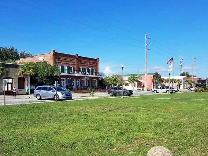 Wide green lawns and historic brick buildings create a town square that feels refreshingly unhurried and authentic.