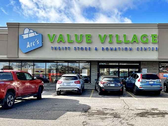 Arc's Value Village's bright green signage pops against the blue sky. A colorful promise of the rainbow of finds waiting inside.