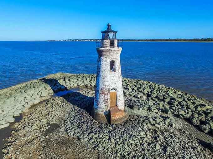 Standing sentinel since the 1800s, this weathered lighthouse guards the river entrance with timeless grace and quiet dignity.