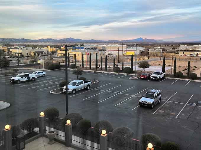 Desert twilight paints the parking lot in pastels while distant peaks stand guard over this peaceful border town.
