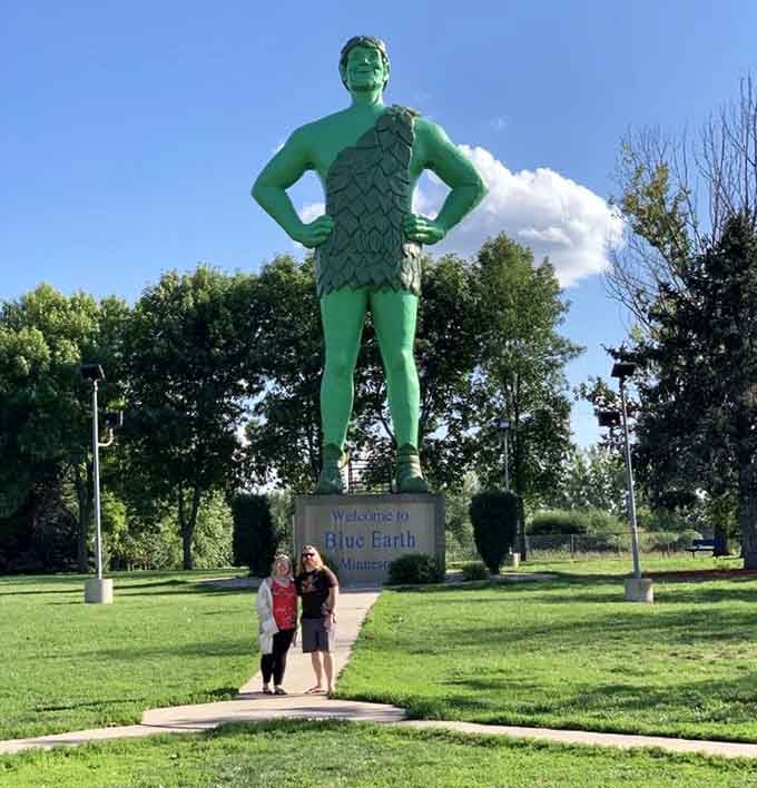 The Jolly Green Giant strikes his iconic pose, standing guard over Blue Earth like a verdant superhero of healthy eating.