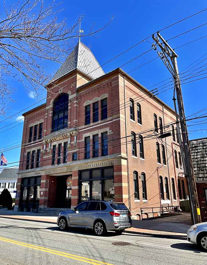 Red brick rises against blue sky with a distinctive tower that's been the town's compass point for generations.