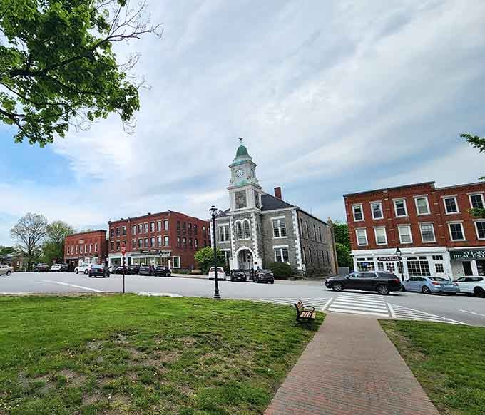 The town green spreads wide and welcoming, framed by brick buildings that have watched generations pass by peacefully.