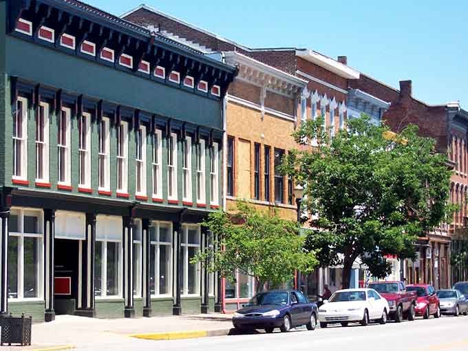 Colorful facades line streets where architectural preservation meets modern commerce in perfect harmony under blue Midwestern skies.