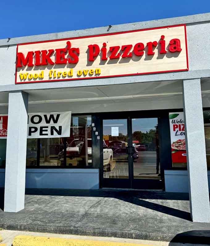 That bold red "MIKES PIZZERIA" sign is like a beacon for wood-fired pizza lovers seeking Neapolitan nirvana.