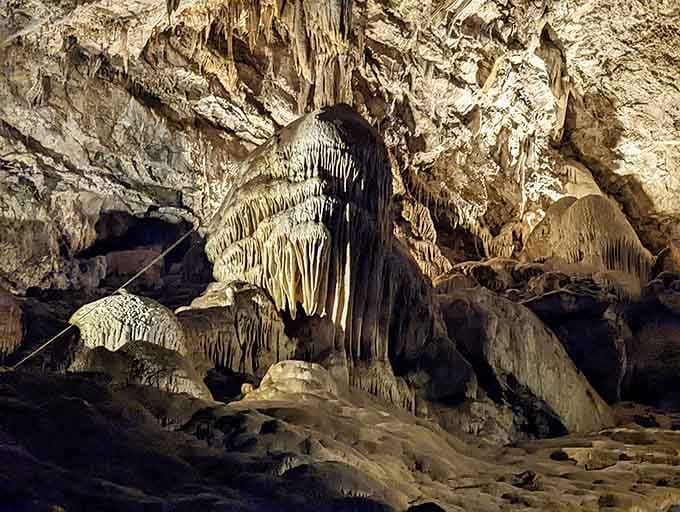 Mineral deposits cascade down the walls in earth-toned waves, creating patterns no artist could ever duplicate perfectly.