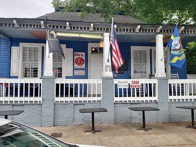 The patriotic flags and welcoming porch give this blue cottage the charm of eating at a friend's house.