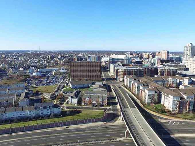 Modern buildings rise along the waterfront while neighborhoods spread beyond, showing a city that's grown without losing its soul.