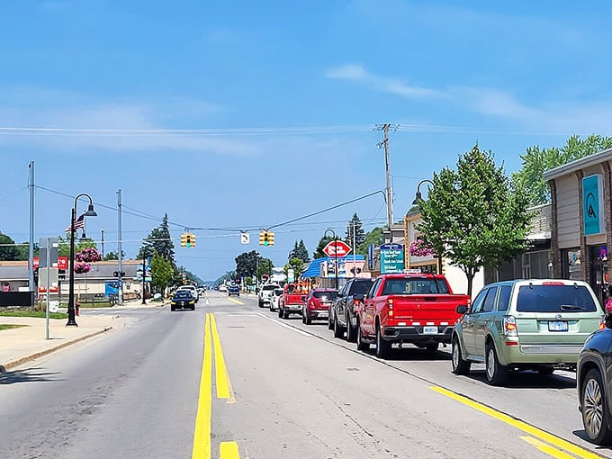 Oscoda's main street stretches toward Lake Huron under summer skies, promising ice cream shops and friendly conversations ahead.