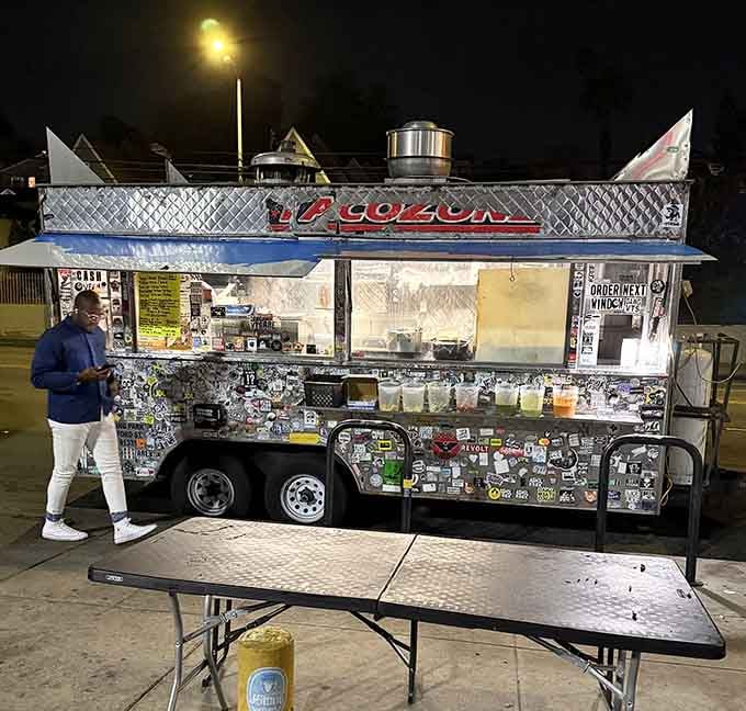 Taco Zone's silver chariot of deliciousness glows under night lights, a beacon for late-night taco hunters with discerning taste buds.