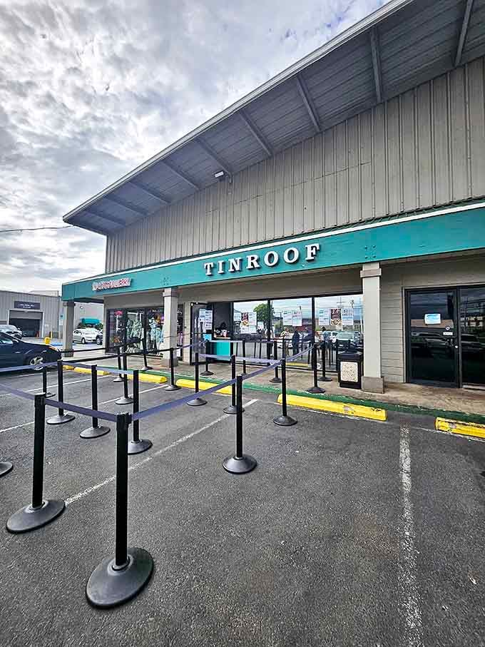 Tin Roof's industrial exterior and queue barriers hint at the popularity within. Where airport-adjacent dining becomes a destination itself.