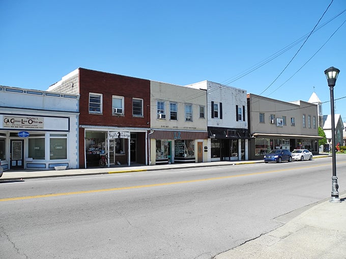 Sunshine bathes these storefronts in golden light, making every shop window look like a stage set for discovery.