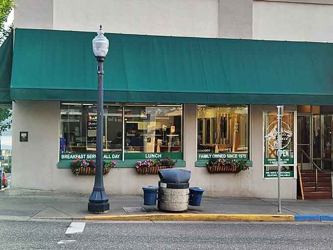 Those flower boxes and green awning signal a downtown gem where breakfast is served with genuine small-town hospitality.