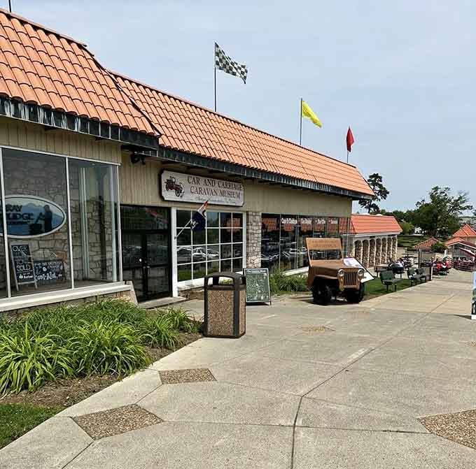 Colorful flags flutter above this museum celebrating transportation history before highways changed everything forever.